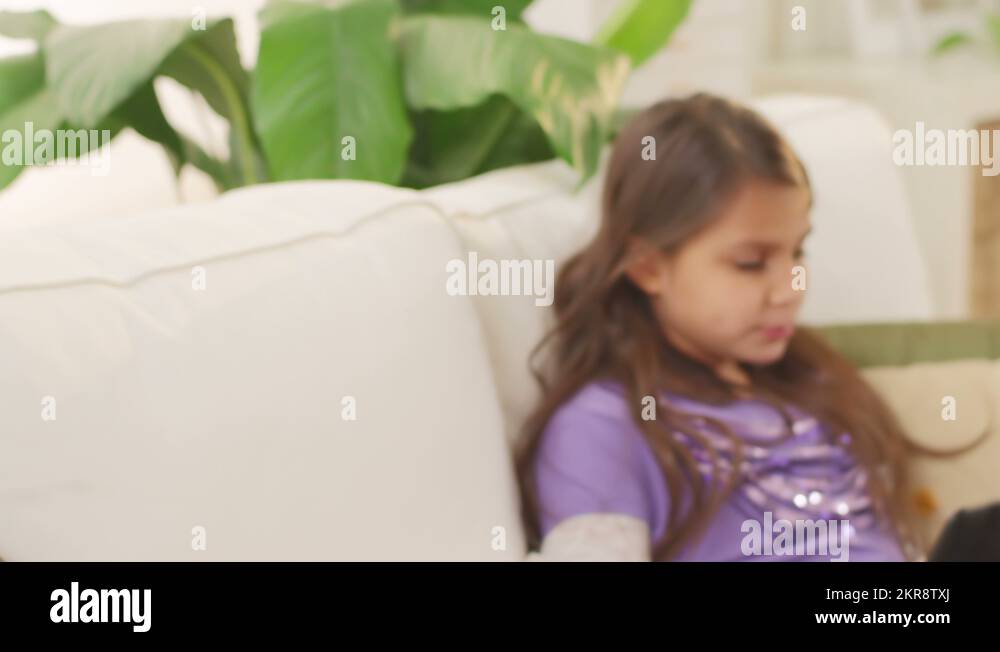 A cute little girl meets her father at the door when he gets home Stock ...
