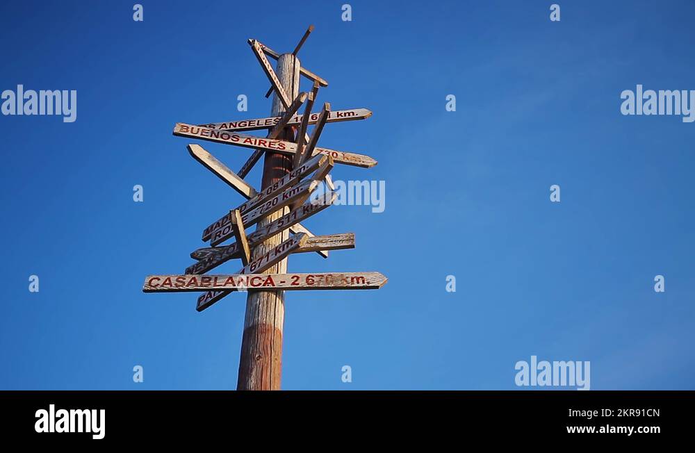 Wooden traffic sign pointing to various cities and directions Stock ...