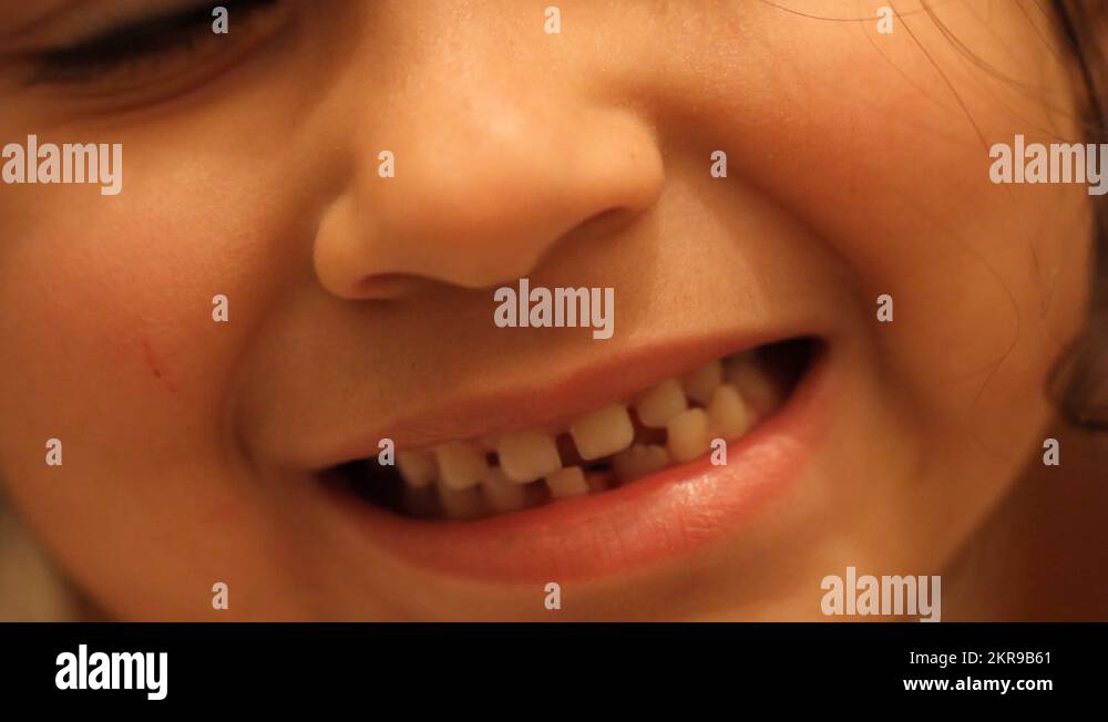 little Girl wiggles her first loose tooth Stock Video Footage - Alamy