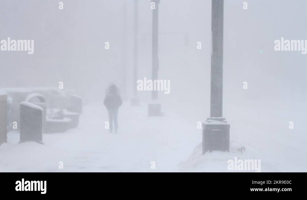 Winter, blizzard in the city, single person walking through heavy ...