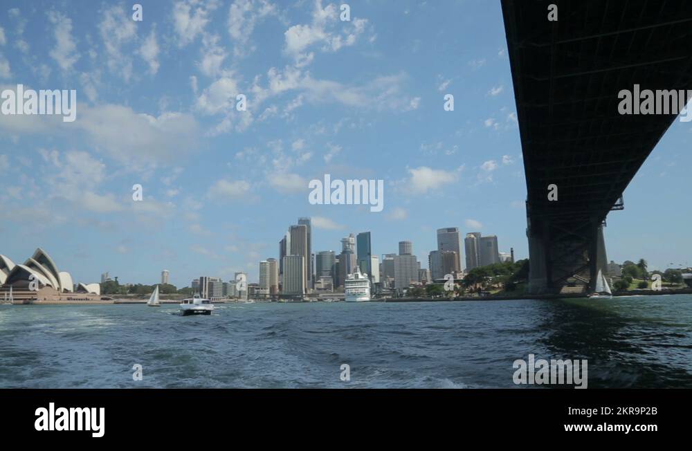 pan shot from moving boat of opera house and sydney harbour bridge ...