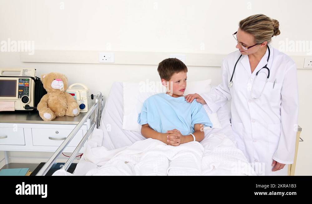 Little sick boy sitting in bed talking with doctor Stock Video Footage ...