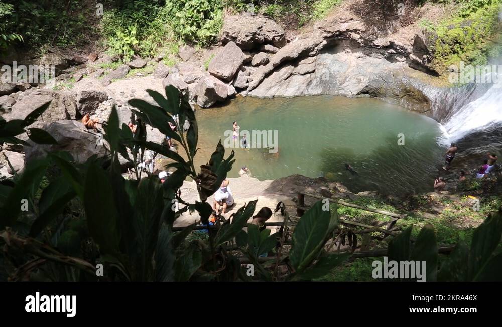 Water falling into pond with swimmers Stock Video Footage - Alamy