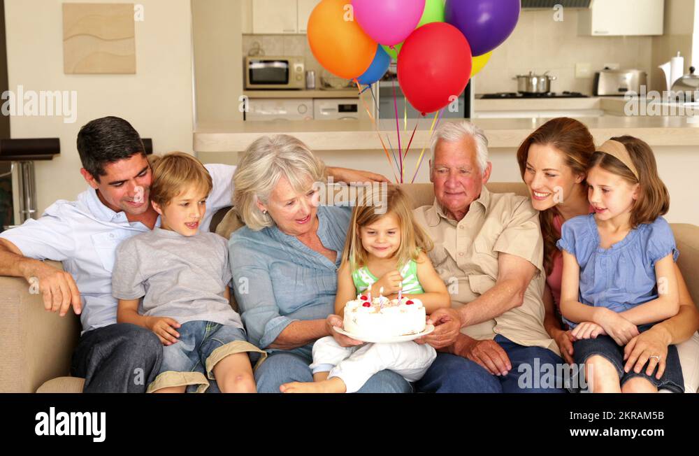 Extended family celebrating little girls birthday on couch Stock Video ...