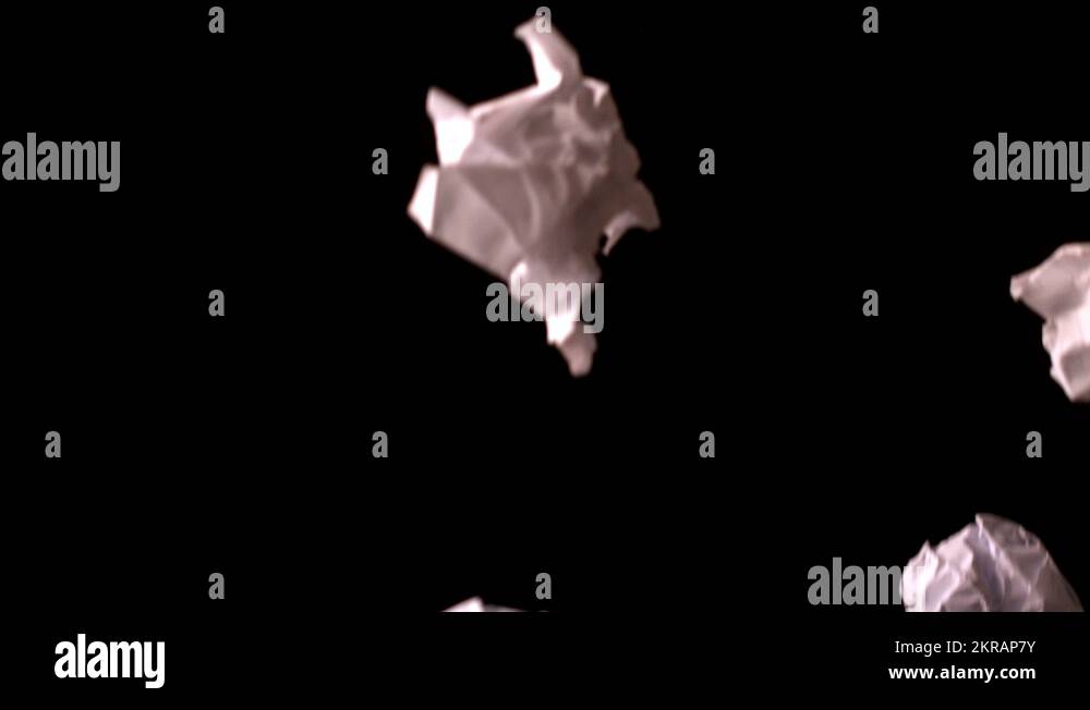 Crumpled paper falling against black background Stock Video Footage - Alamy