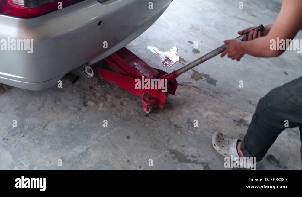 Man lifting car Stock Videos & Footage - HD and 4K Video Clips - Alamy