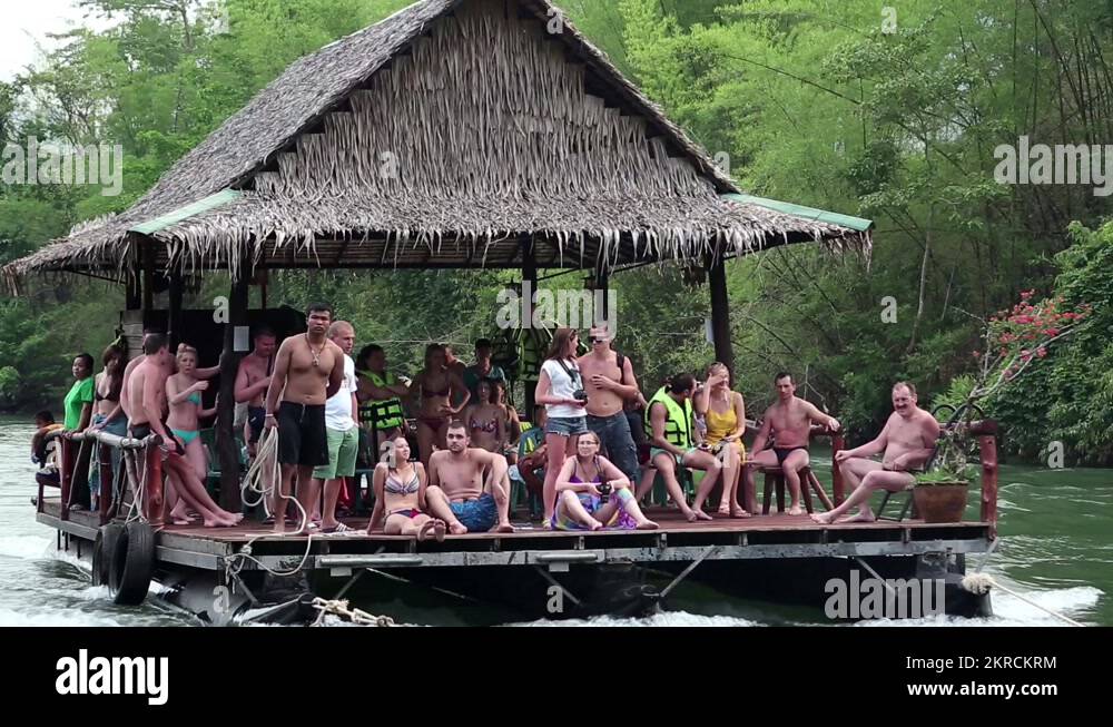 People float on the raft on the Kwai River near Bangkok in Thailand ...