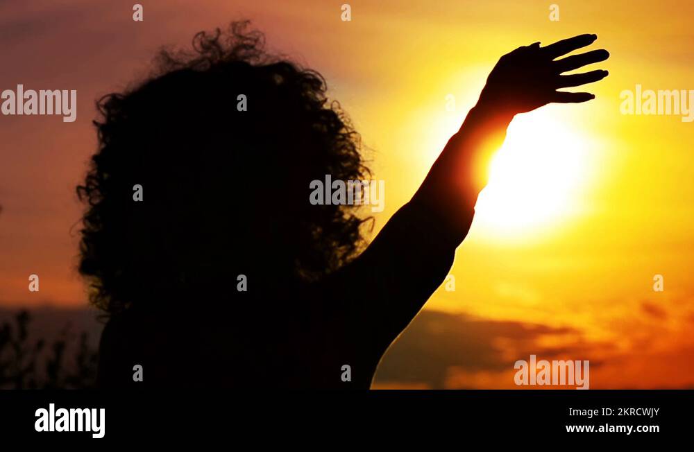 goodbye hand gesture against sunset. romantic sunset farewell female ...