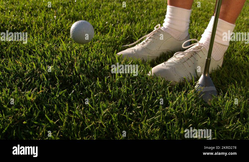 Golf ball falling beside lady golfers feet and club Stock Video Footage ...