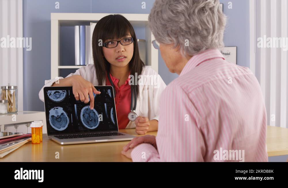 Chinese doctor explaining brain scans to elderly patient Stock Video ...