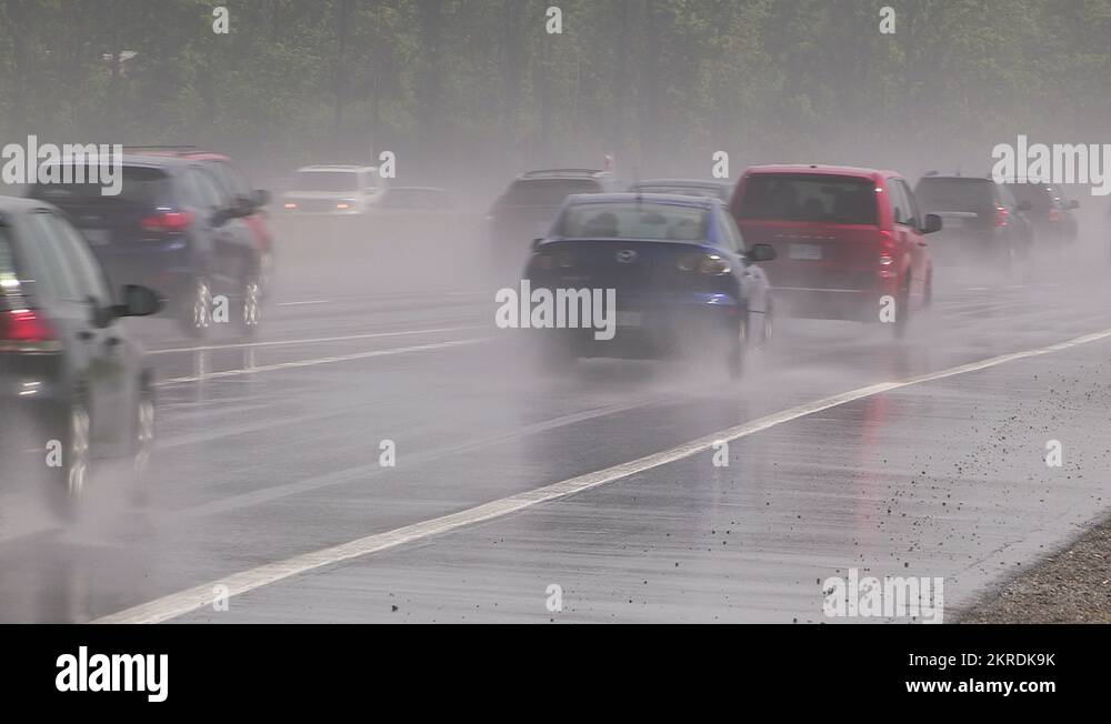 Cars and trucks driving on the highway in heavy rain storm Stock Video ...