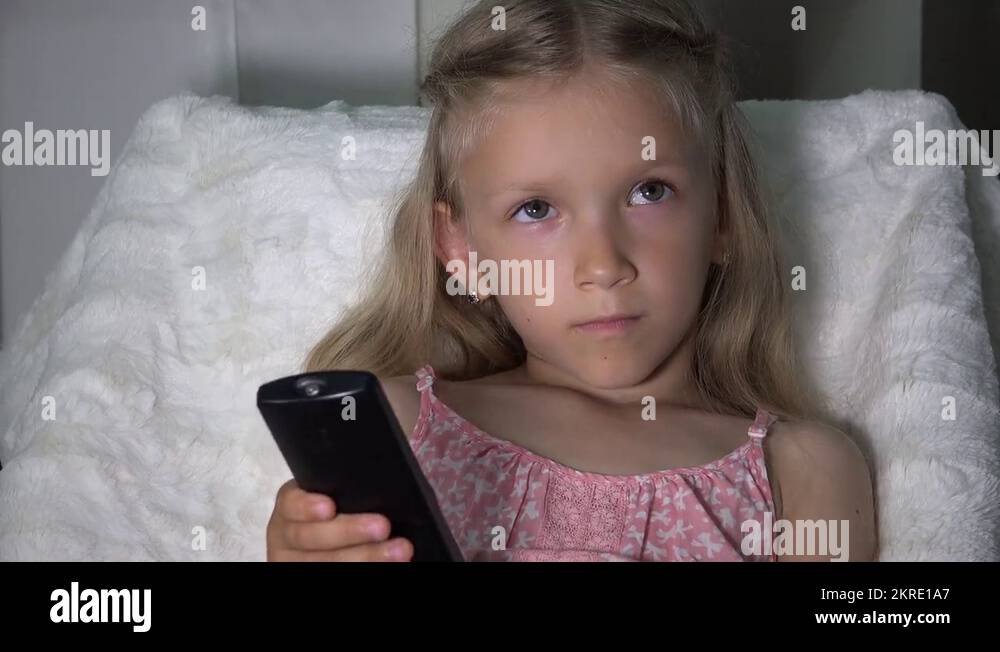 Ultra HD 4K Child Watching TV, Girl Remote Control on Coach, Close Up ...