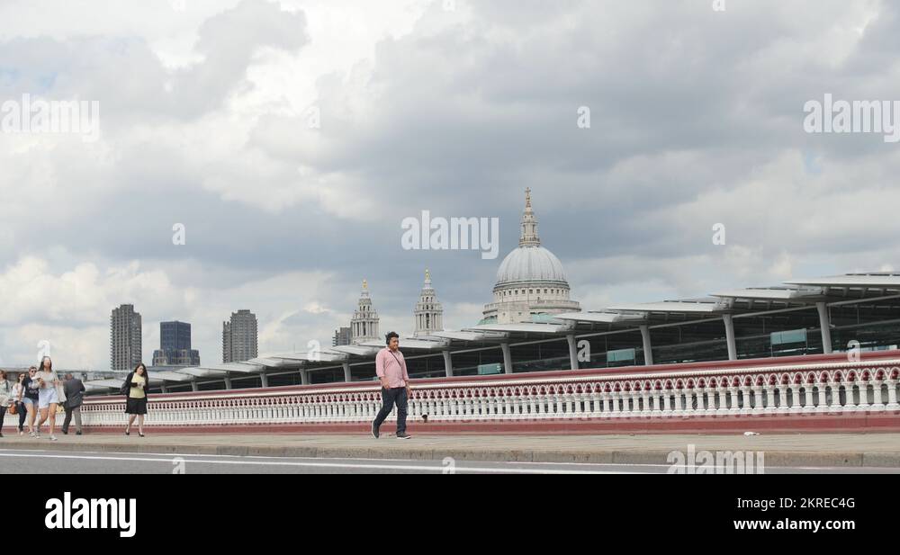 Pedestrians walk over bridge, St Pauls background 4K Stock Video ...
