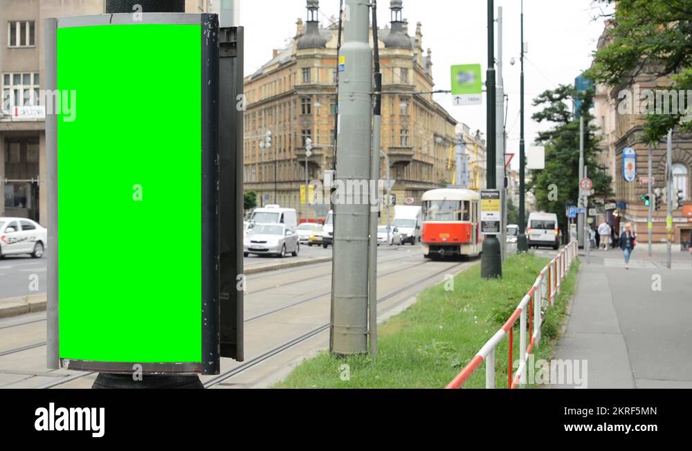 billboard - green screen - urban street with passing cars and trams and ...