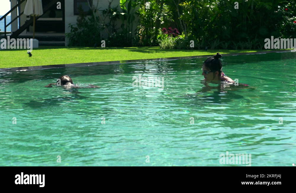 Mother and her son having fun while diving in the swimming pool Stock ...