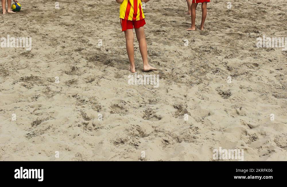 legs soccer football kids playing game in the sand ,kids enjoy in sport ...