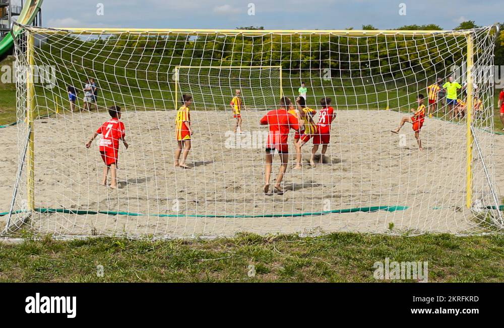 soccer football kids playing game in the sand ,kids enjoy in sport ...