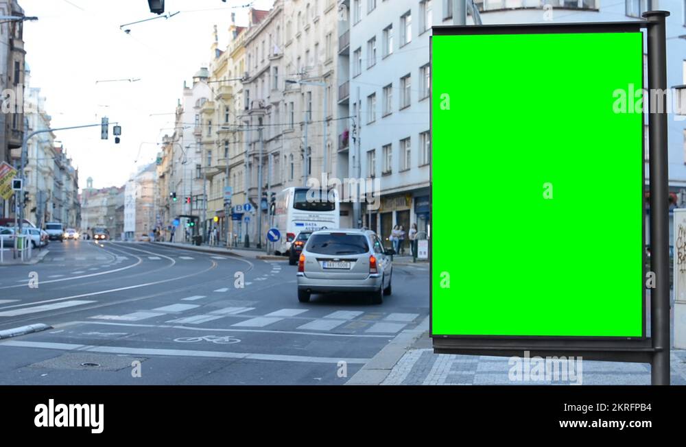 billboard - green screen - urban street with passing cars and trams and ...