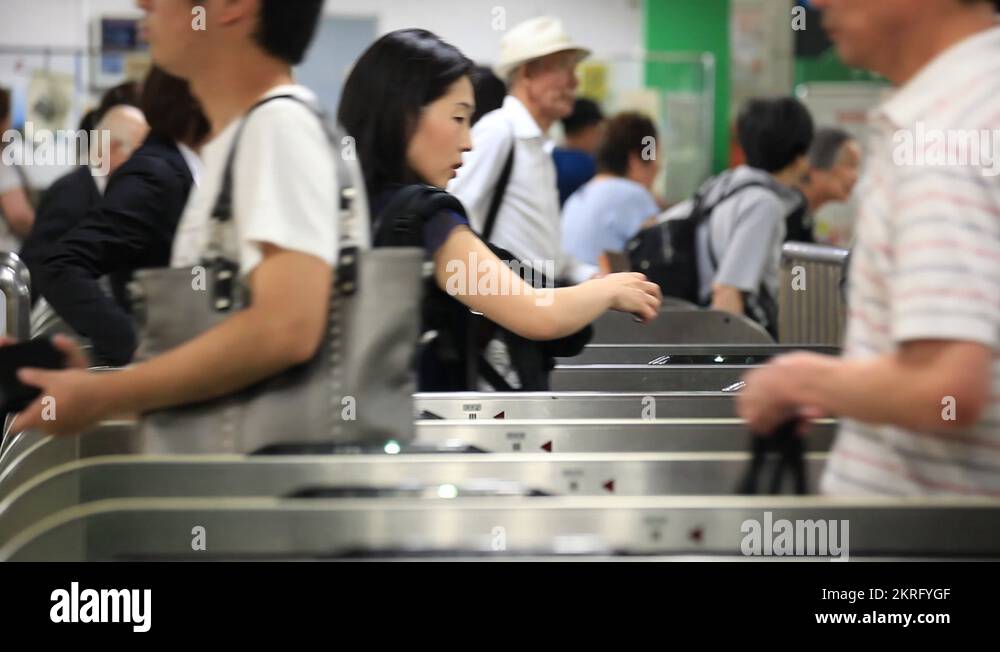 Commuters passing through ticket gate at Shinjuku station, Tokyo, Japan ...