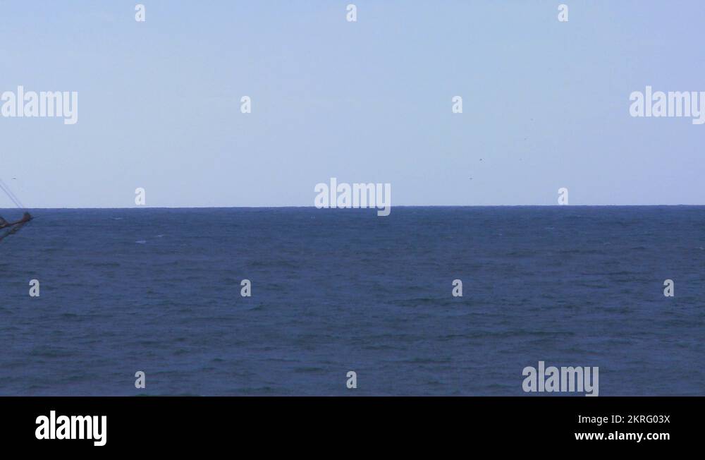 A tall masted ship sails on the ocean without sails unfurled Stock ...