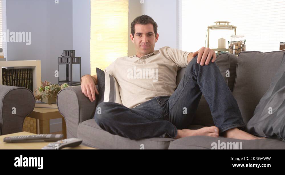 Man lounging on sofa Stock Videos & Footage - HD and 4K Video Clips - Alamy