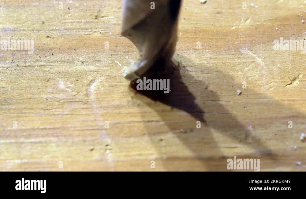 4k Drill bit boring a hole in piece of wood - Construction and building ...
