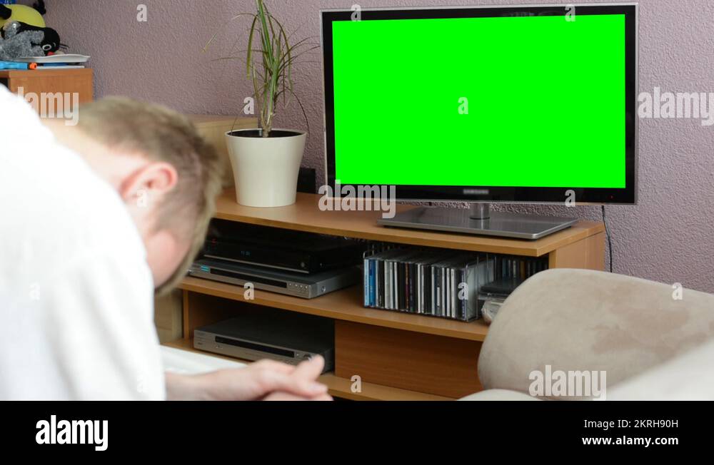 Man watches TV(television) - green screen - man laughs Stock Video ...