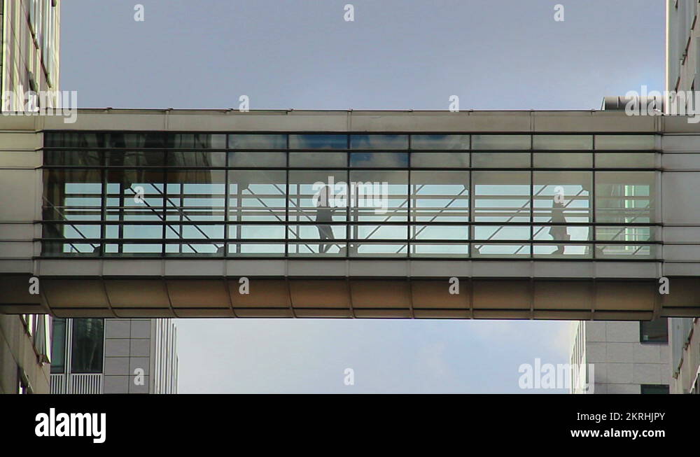 Two buildings transition business woman crosses terminal passage Stock ...