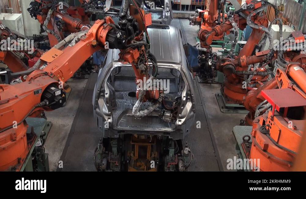 Robots weld car parts in production line at factory. Car factory Stock ...