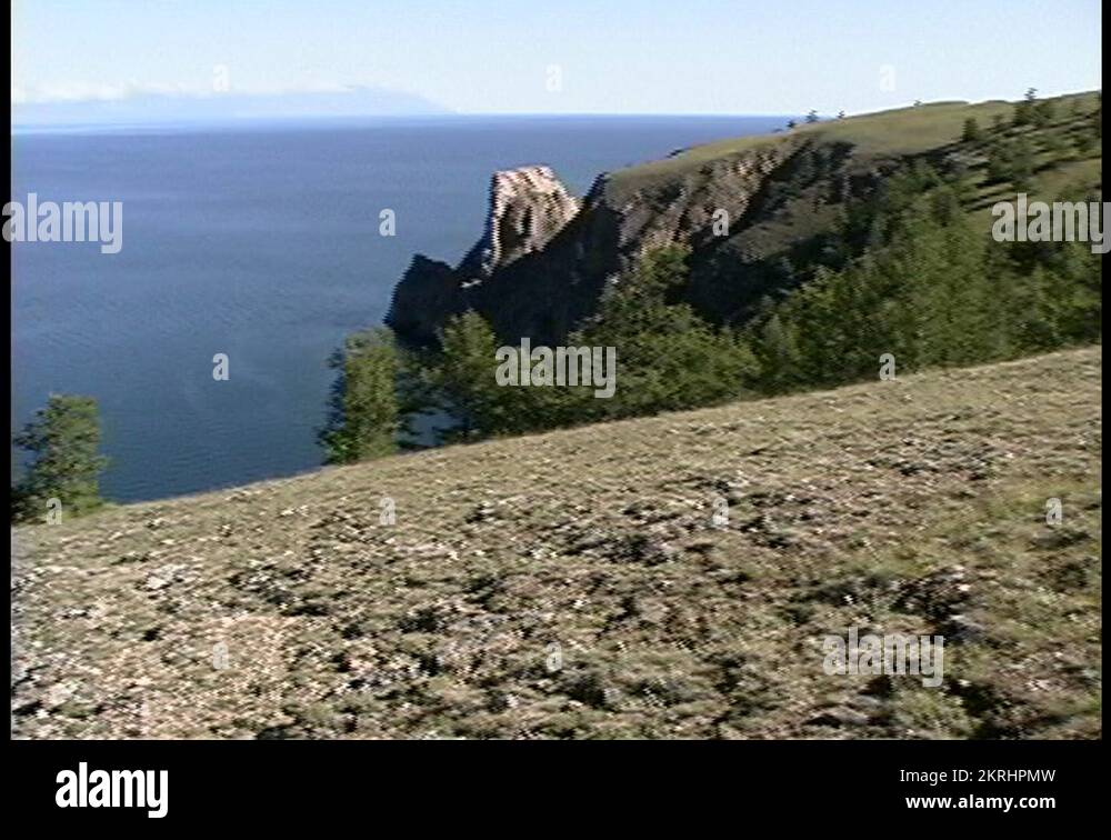A pan-left of an ocean, viewed from the edge of a steep cliff Stock ...
