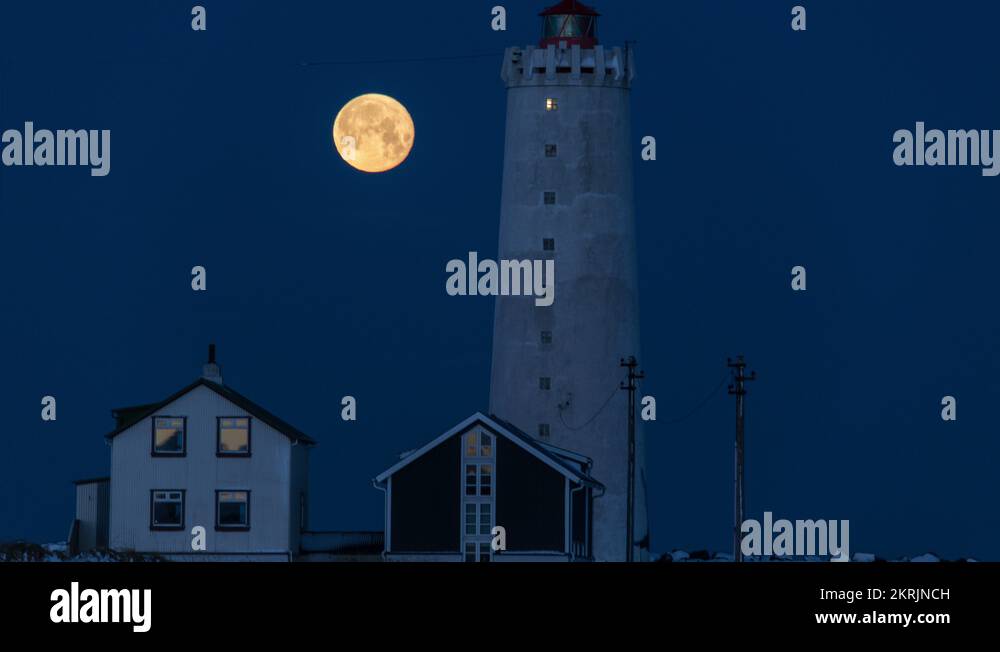 Detailed full moon setting behind Grotta light house, Reykjavik ...