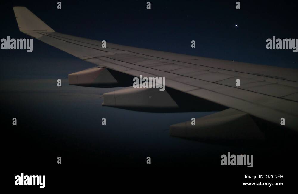 Lights turn on plane wing at night during flight TL 4K Stock Video ...