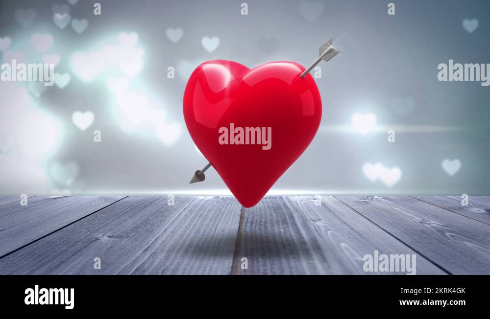 Red heart with an arrow turning on glittering background Stock Video ...