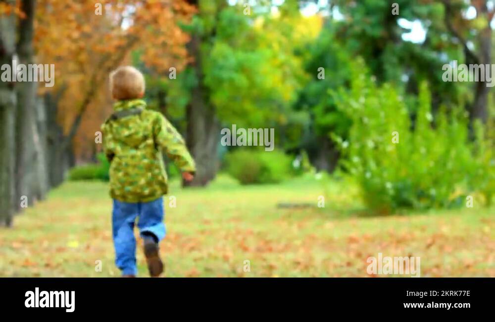 cute 4 year old little boy running away in park. beautiful child. happy ...