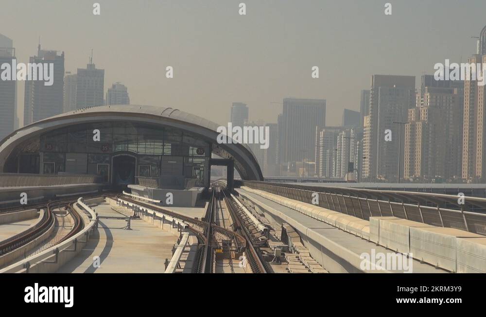 POV Point of view Dubai metro train enter station modern district ...