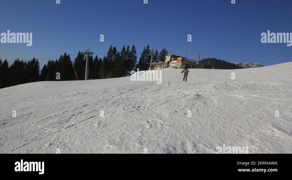 Sun Flared Slow Motion 4K Of Skier Carving Down The Slope And Then ...