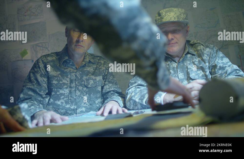 4K Military officers in army bunker, looking at map & discussing battle ...