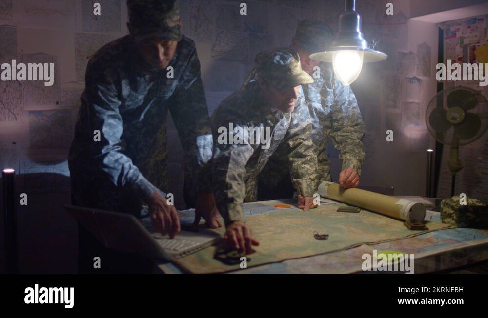 4K Military officers in army bunker, looking at map & discussing battle ...