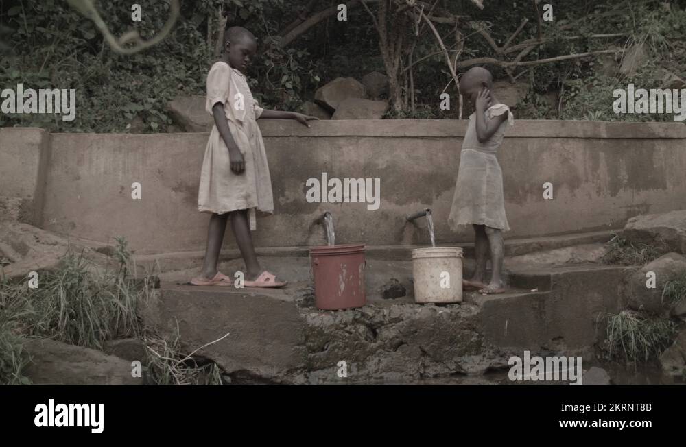 Africa poor African girls fill and carry water bucket pan Stock Video ...