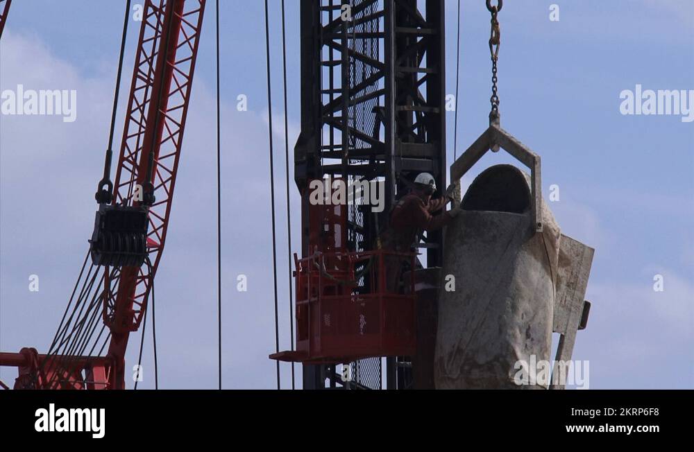 Construction site - medium shot - hoisting concrete box for cast-in ...