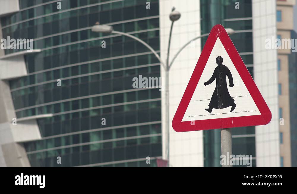 Doha, Qatar, road sign, pedestrian crossing, traditional dress, Middle ...