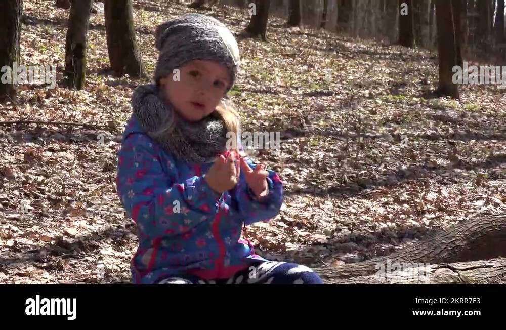 Cute Girl Sitting on Old Pine Tree in Early Spring Forest and Playing ...