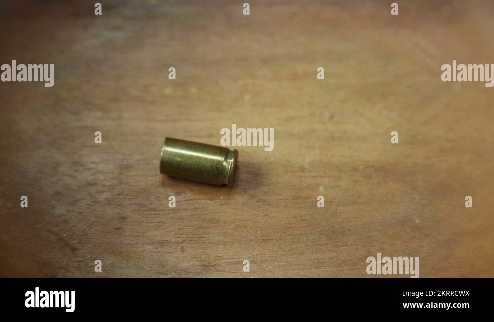 Bullet casing rocking back and fourth coming to rest at center Stock ...