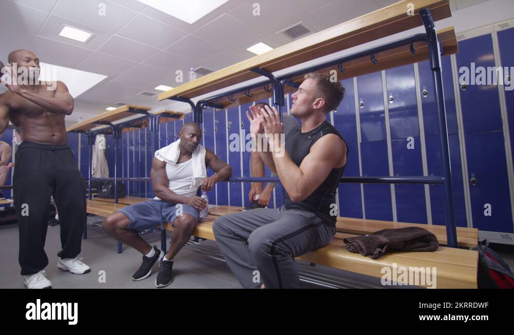 4K Sports team or gym buddies in high spirits in the locker room Stock ...