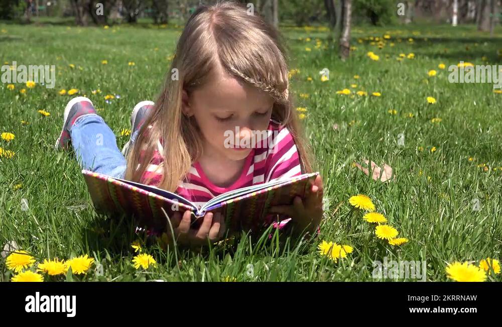 4K Child Little Girl Reading a Storybook in Park, Kid Playing Book ...