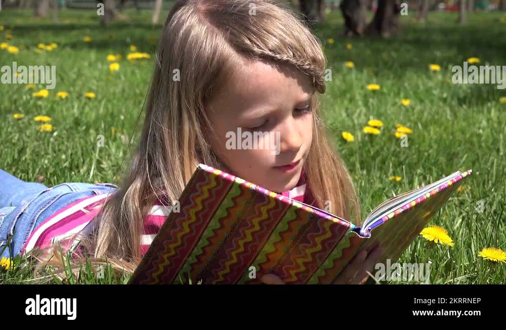 4K Child Little Girl Reading a Storybook in Park, Kid Playing Book ...