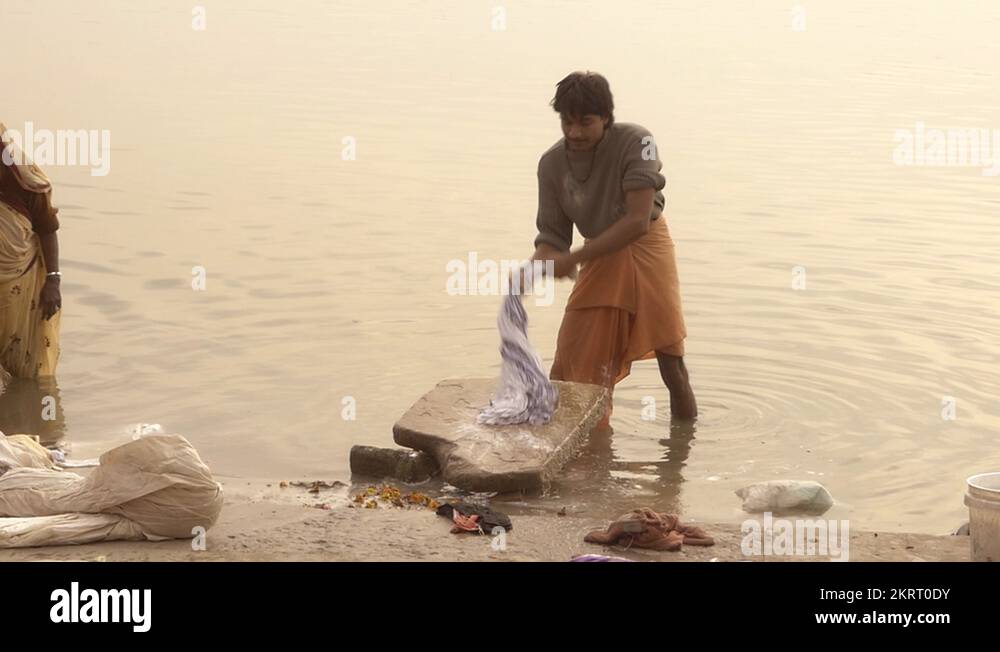 Varanasi, india, man washing clothes in sacred ganges river Stock Video ...