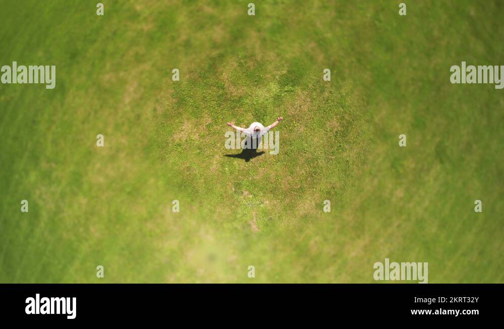 3516 Aerial Flying Over Man with Hands Lifted Up in Grass Field, 4K ...