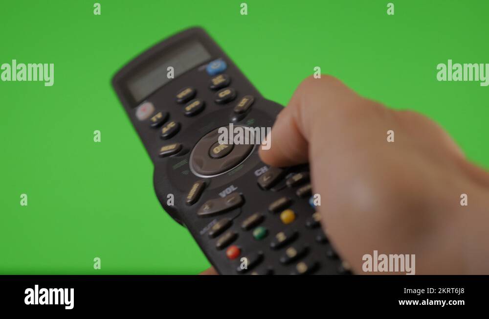 Remote control changing channels in front of green screen background 4K ...