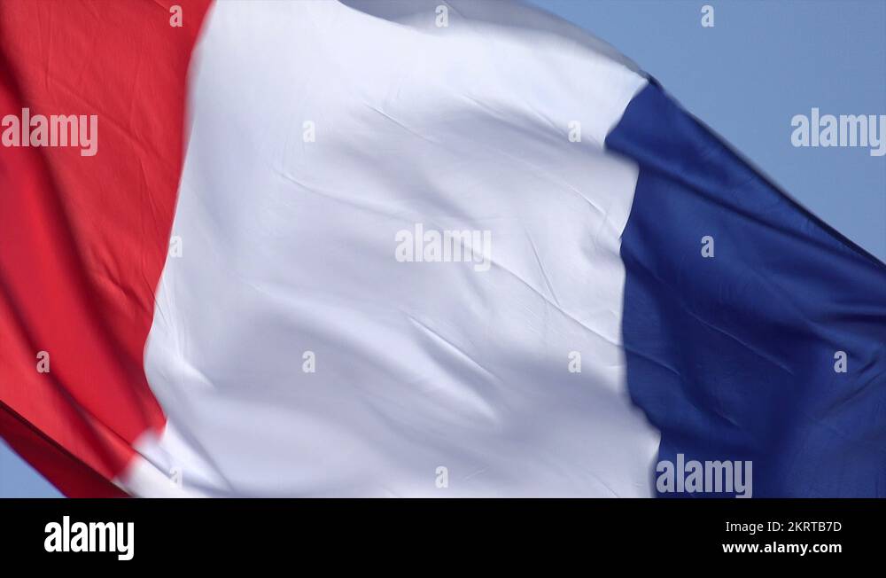 French flag blowing in wind with blue sky background, France Stock ...